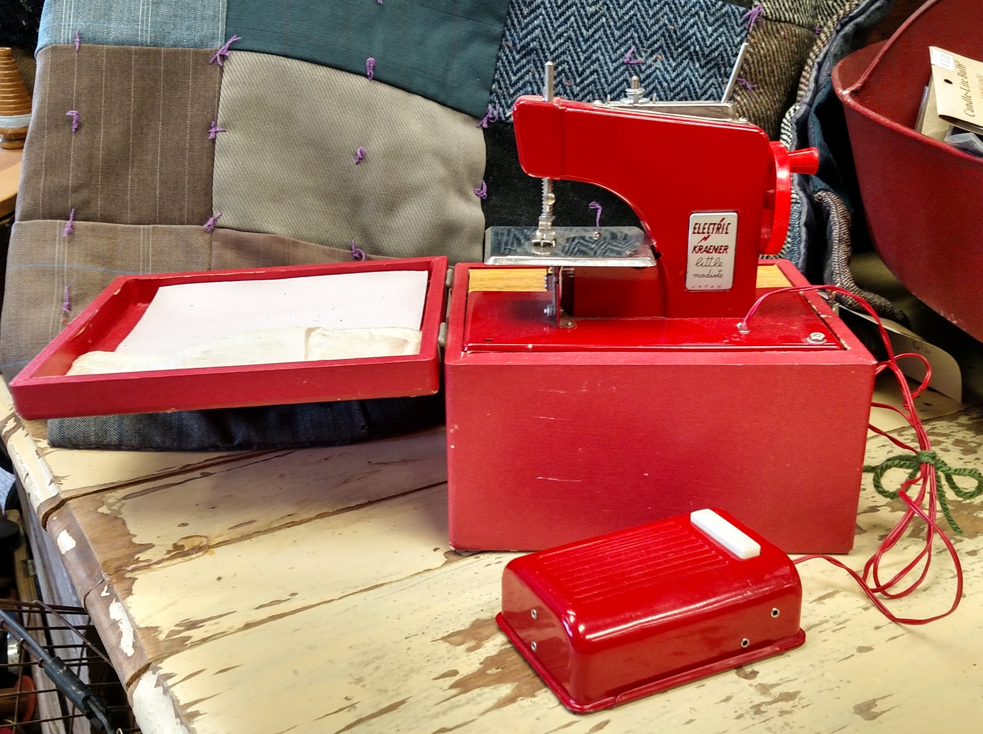 Bright Red Toy Sewing Machine for a Cheerful Sewing Room Decoration.
