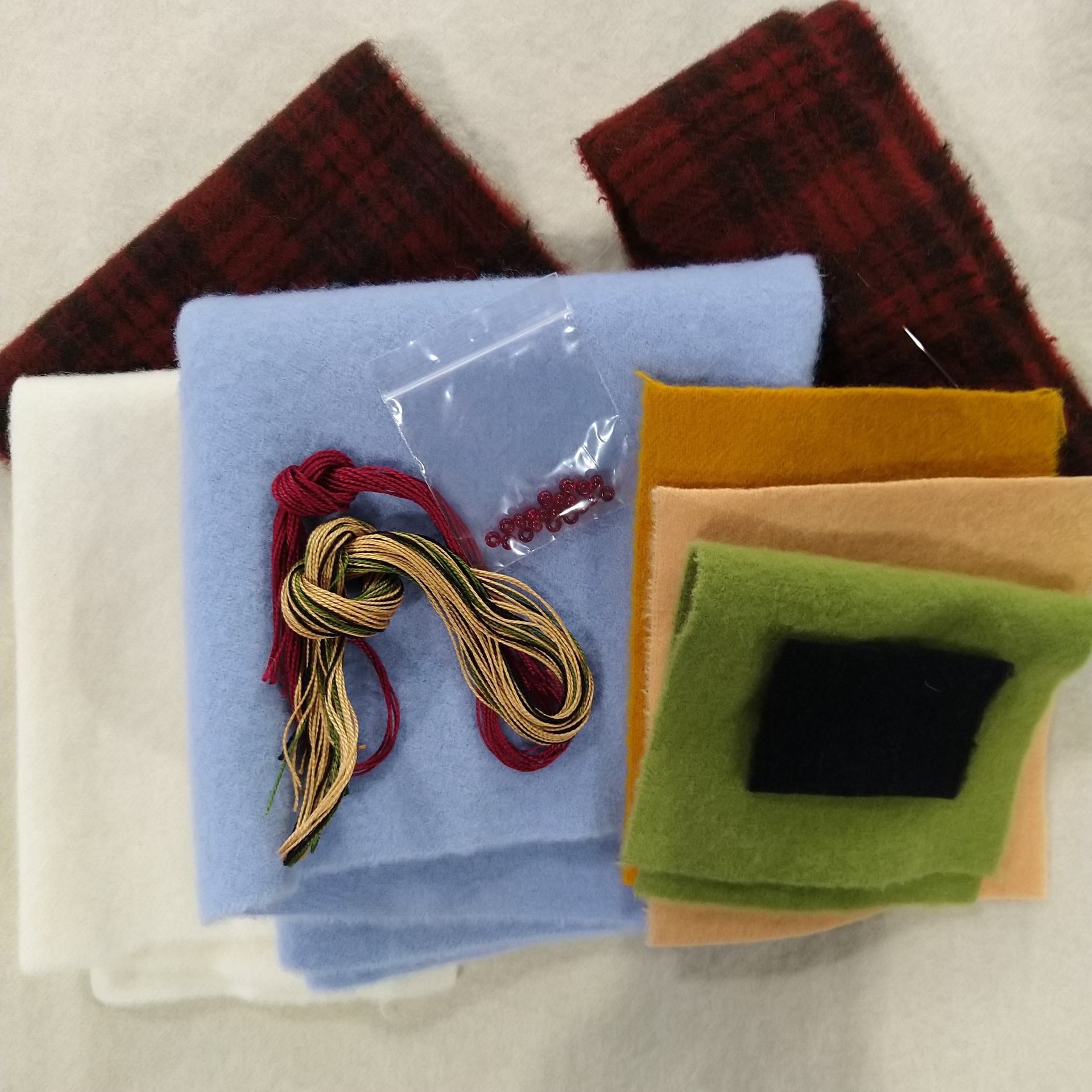 A jolly Wool Applique Santa With a Clever Dimensional Beard.