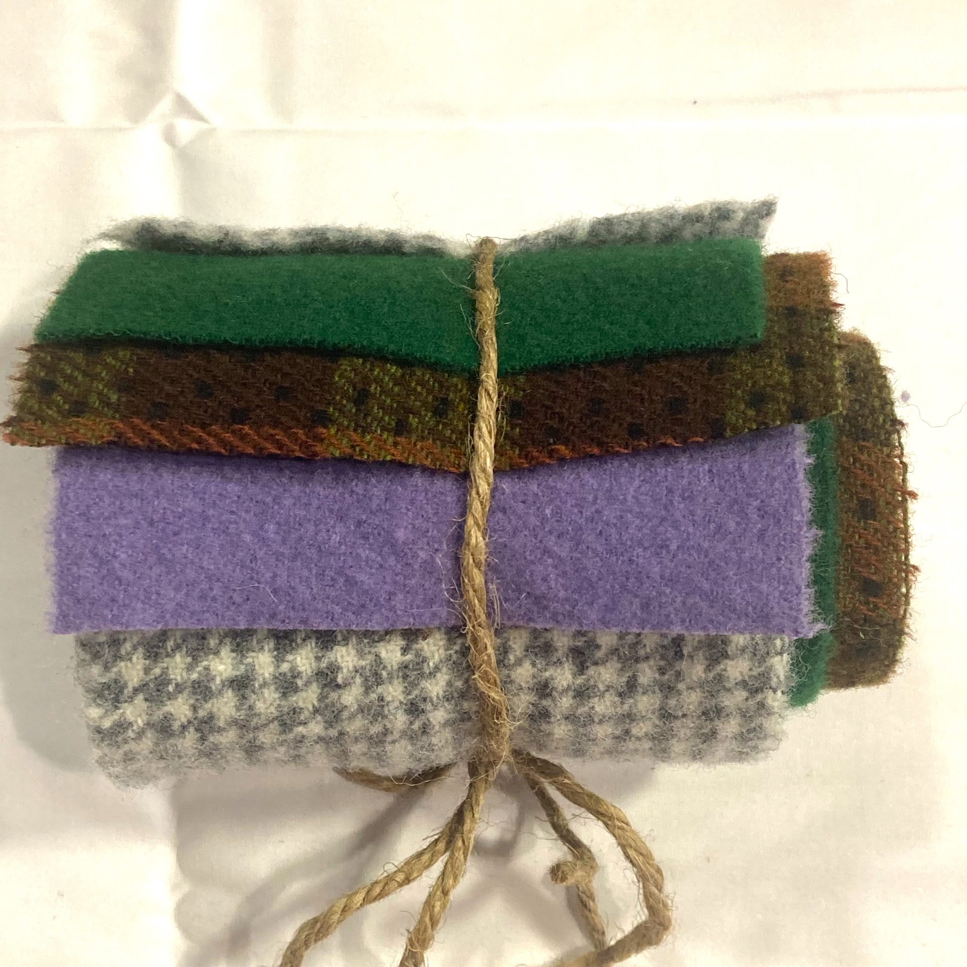 4 strips of a variety of 100% Wool Pieces pre-felted (4" x 16" or longer).